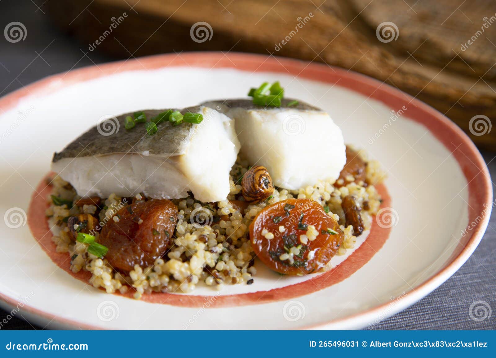 Cod Loins Cooked in the Oven with Quinoa and Peach. Stock Image - Image ...