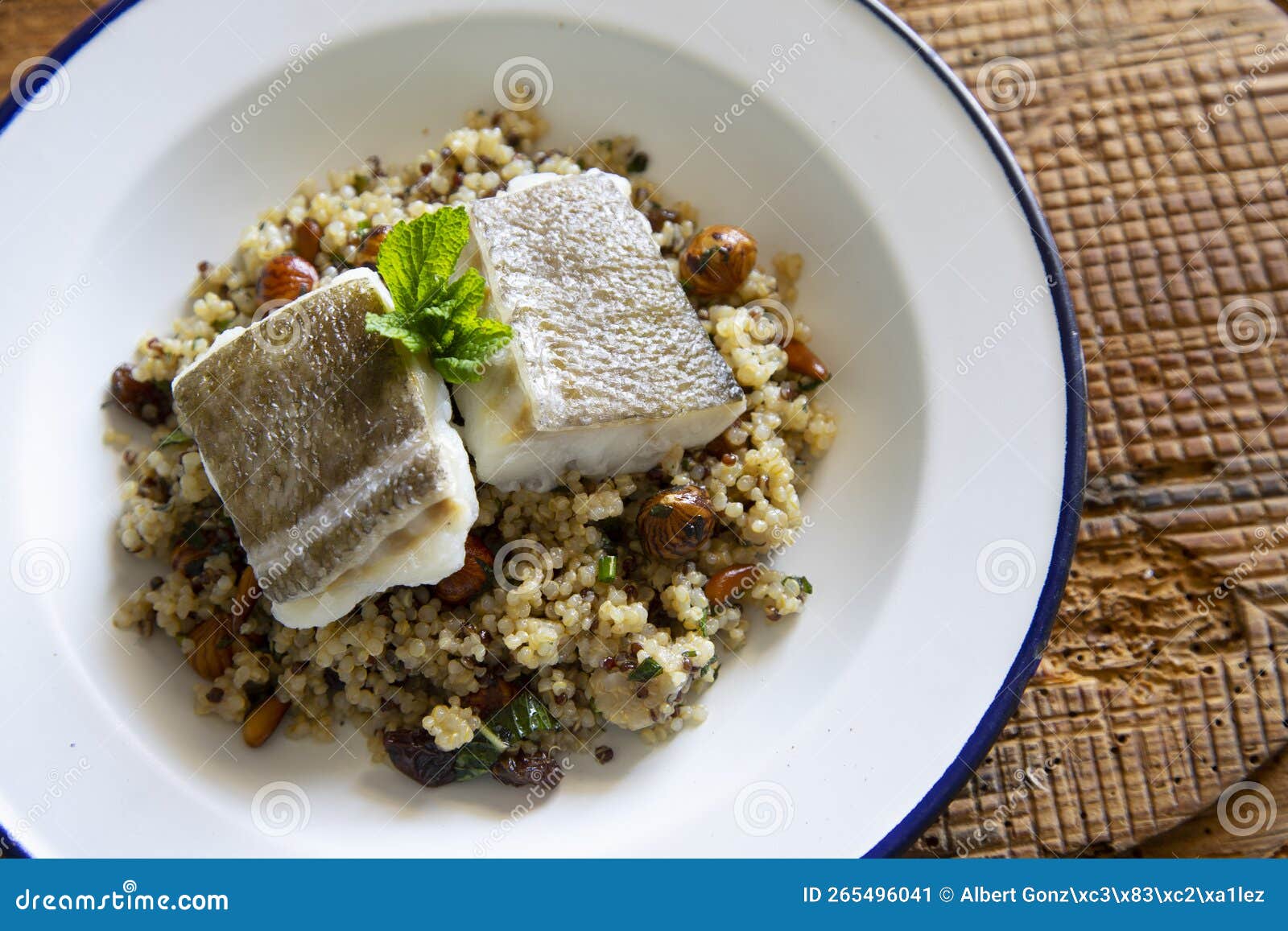 Cod Loins Cooked in the Oven with Quinoa and Peach. Stock Image - Image ...