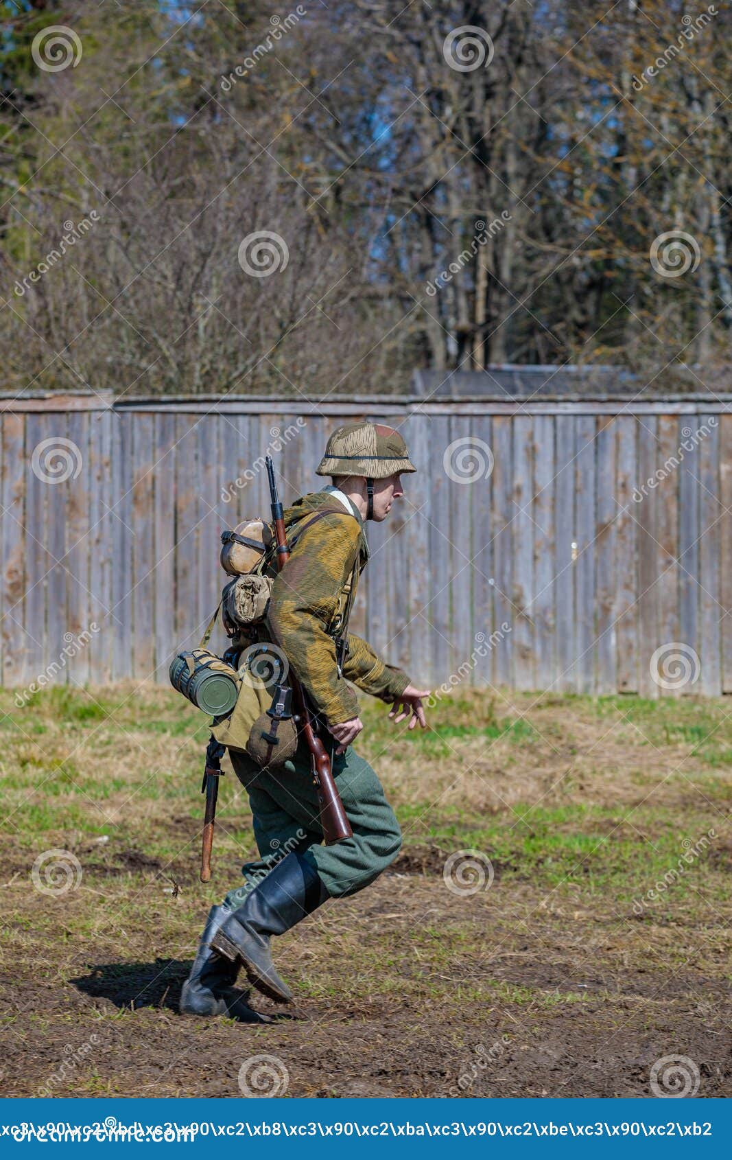 Reconstruction of the Second World War. a German Soldier is Running ...