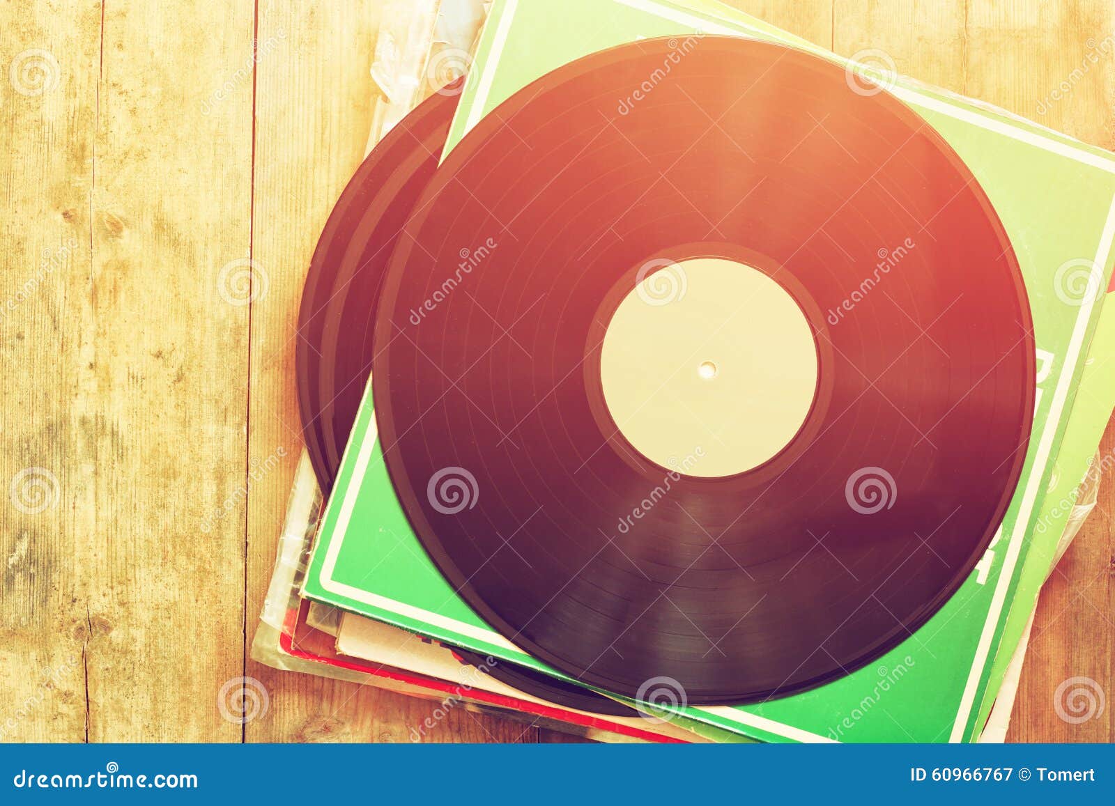 Records Stack with Record on Top Over Wooden Table. Stock Image - Image ...
