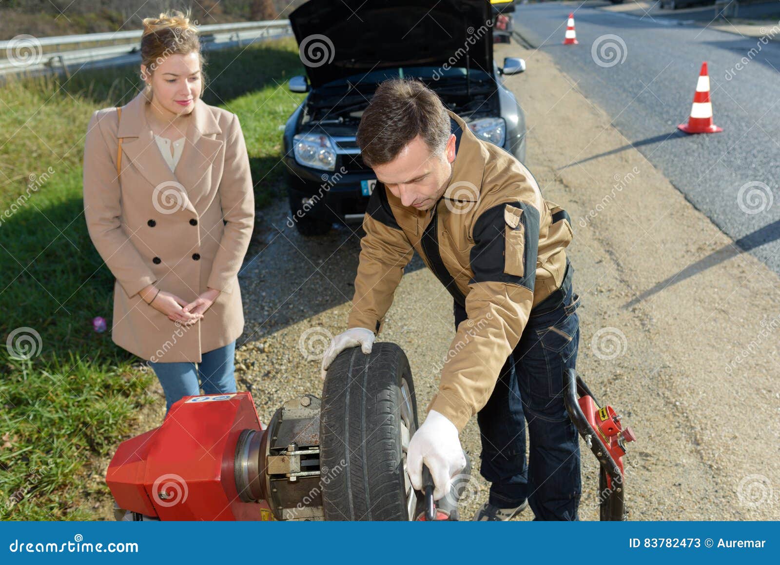 Recovery Man Changing Tyre beside Road Stock Image - Image of tire ...