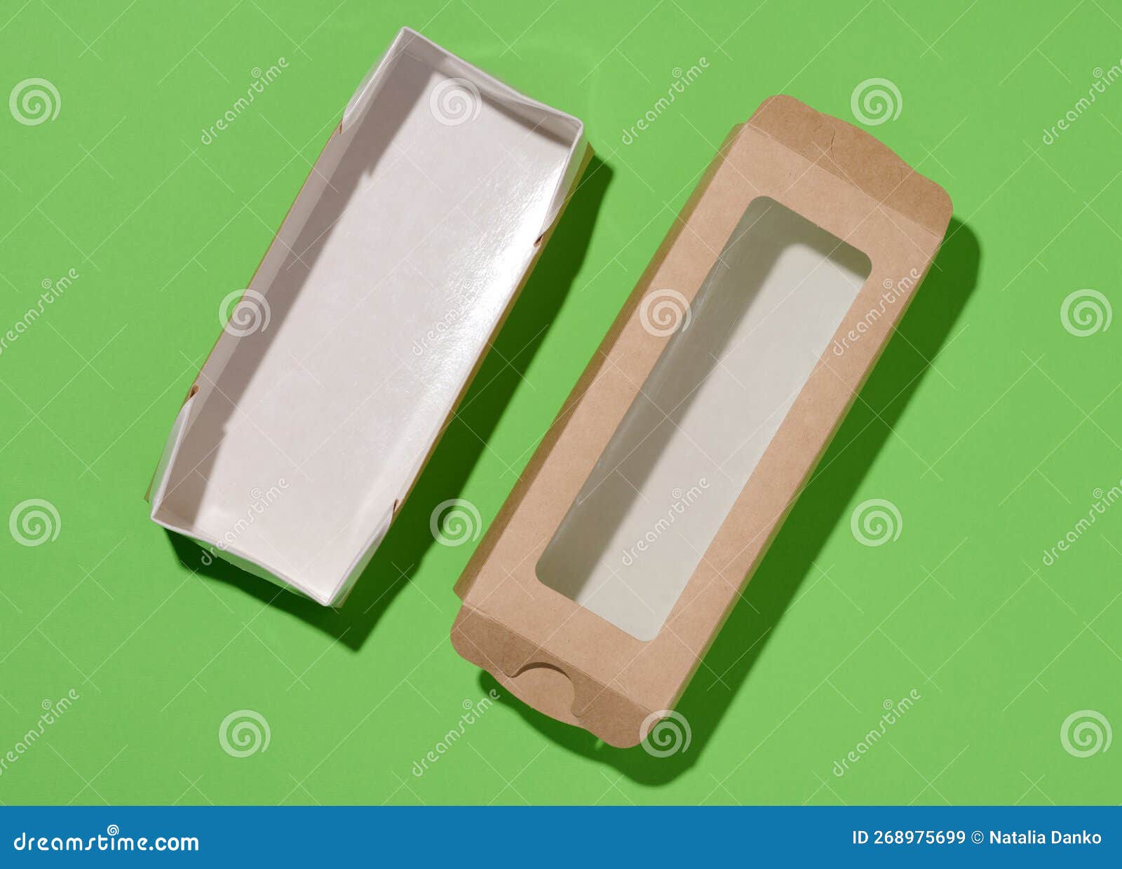 Rectangular Cardboard Box with a Transparent Plastic Lid on a Green ...