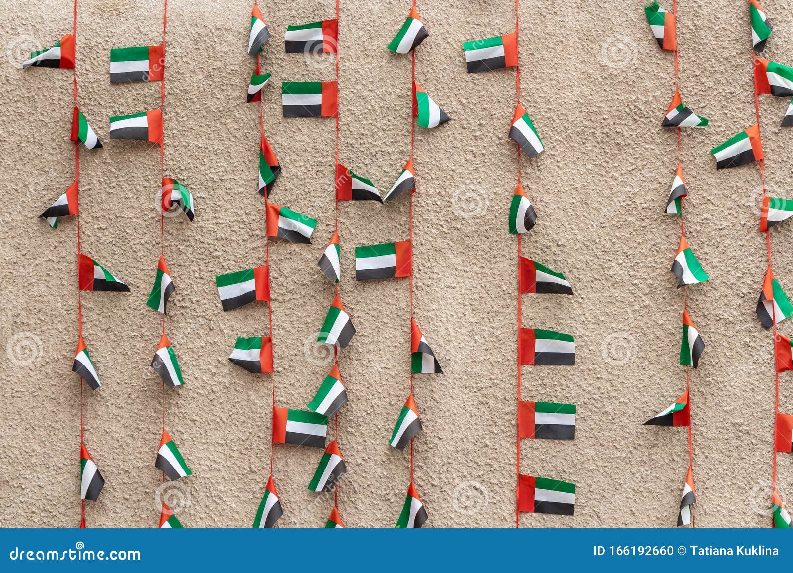 Rectangular Colored Flags Hang on a Red Rope on the Yellow Wall ...