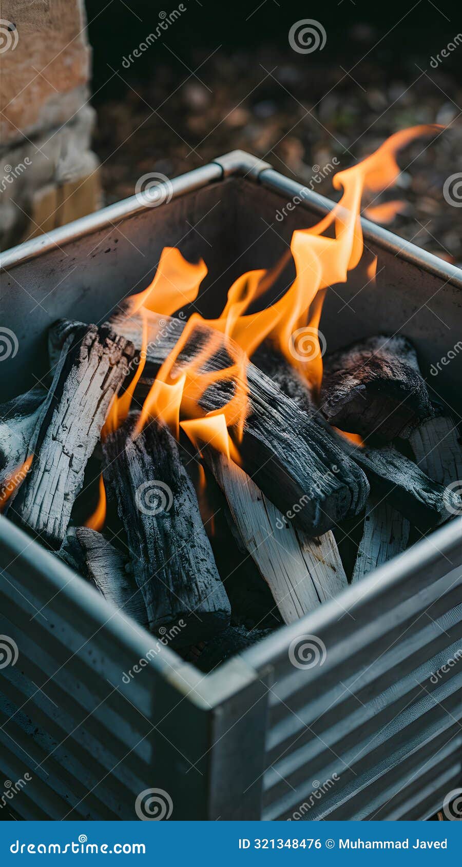 Rectangular Metal Fire Pit Filled with Charred Wood, Emitting Bright ...