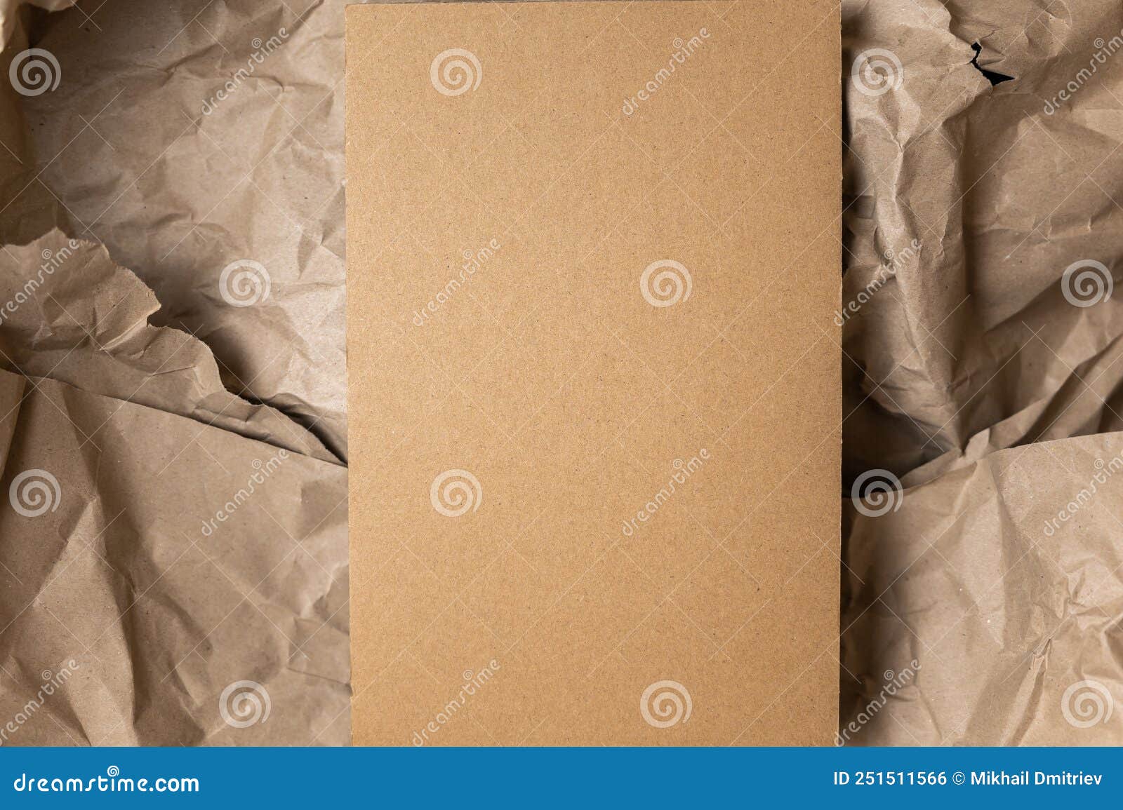 Rectangular Piece of Brown Cardstock Against Crumpled Wrapping Paper ...