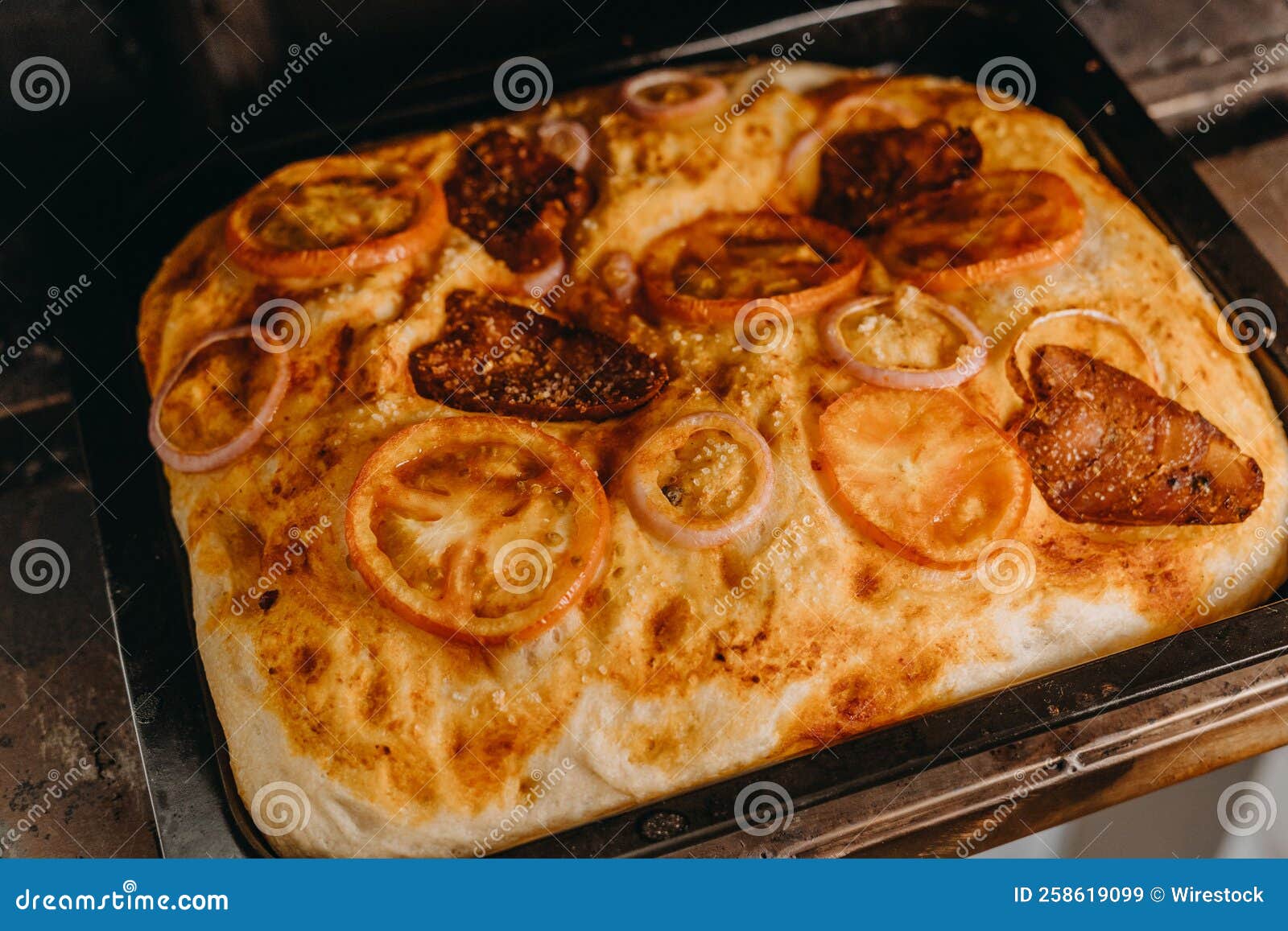 Rectangular Pizza with Onions, Tomatoes and Meat on a Pan Stock Image ...