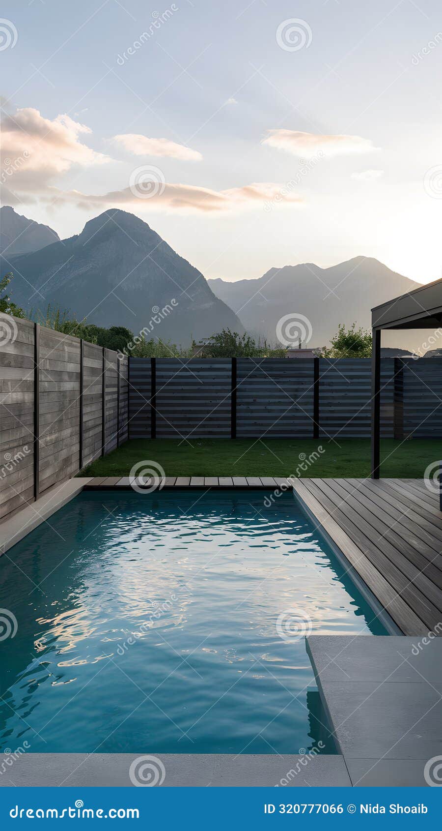 Rectangular Pool Bordered by Wooden Decking, Stylish Fence, Grassy Lawn ...