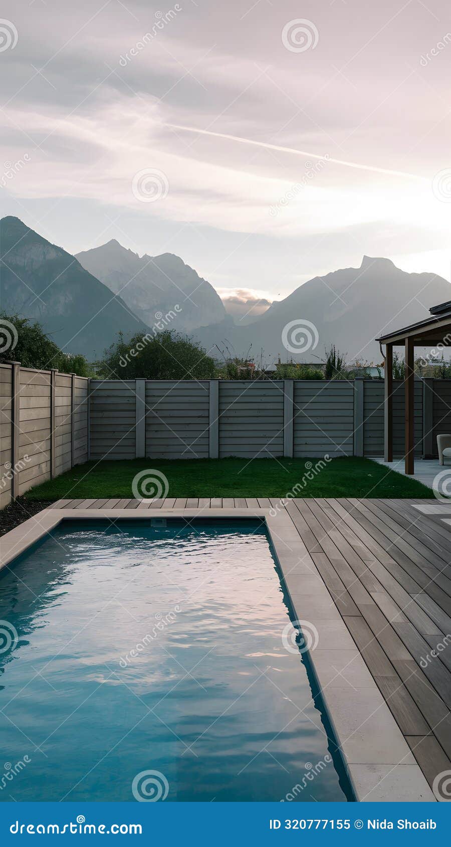 Rectangular Pool Bordered by Wooden Decking, Stylish Fence, Grassy Lawn ...
