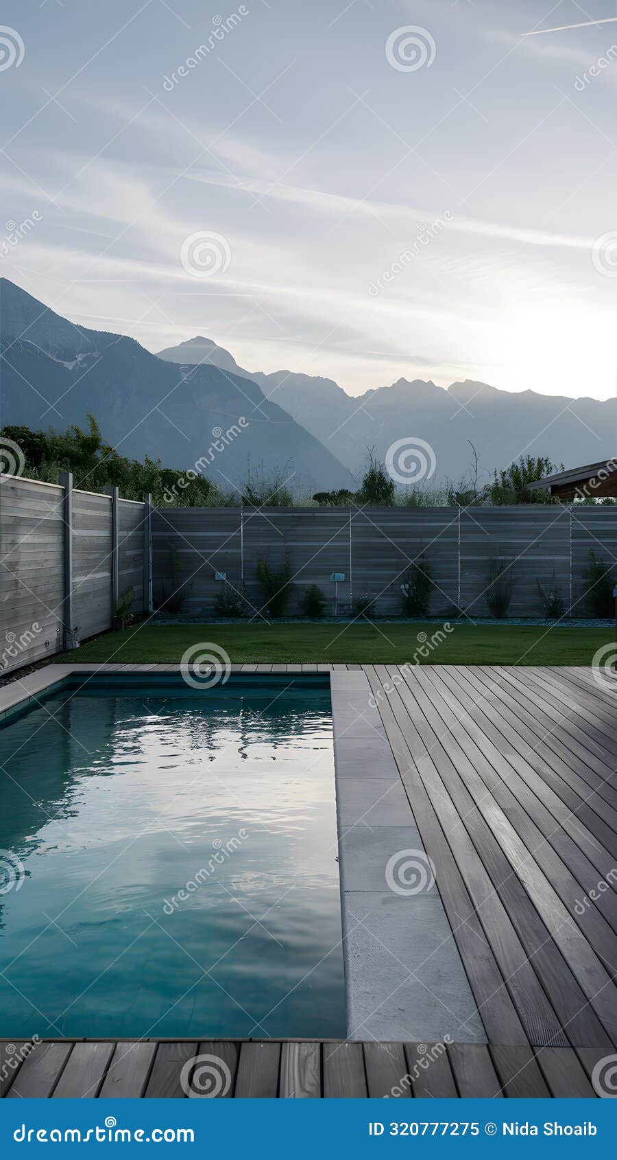 Rectangular Pool Bordered by Wooden Decking, Stylish Fence, Grassy Lawn ...