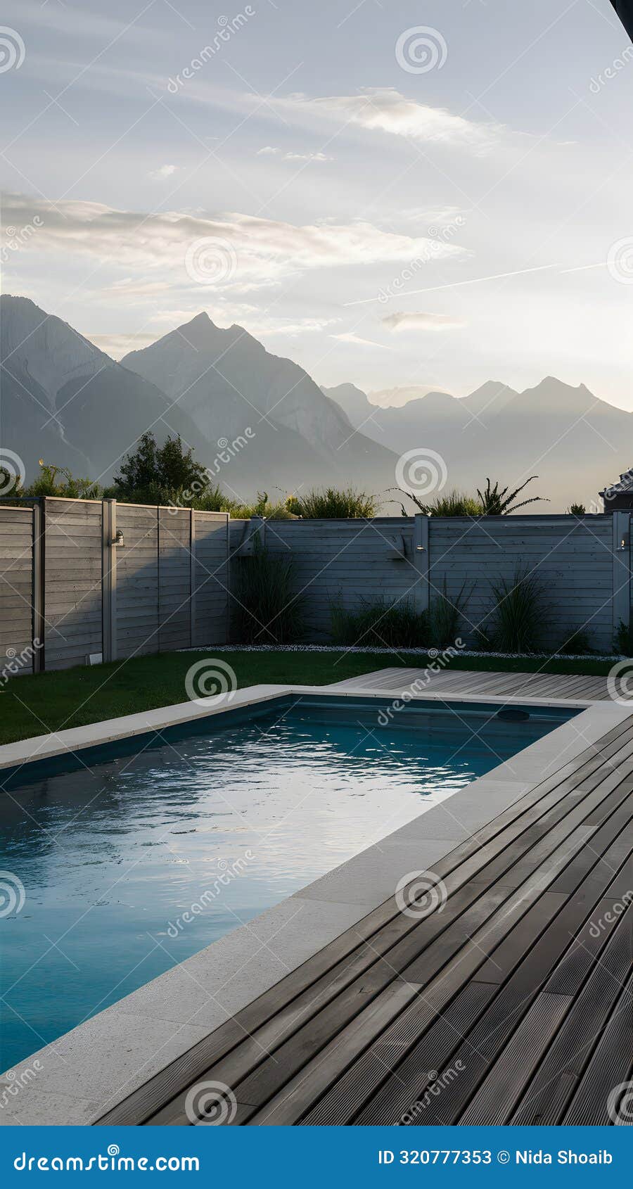 Rectangular Pool Bordered by Wooden Decking, Stylish Fence, Grassy Lawn ...