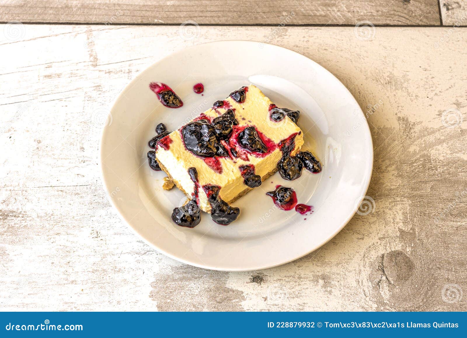 Rectangular Portion of Cheesecake with Blueberry Jam and Compacted ...