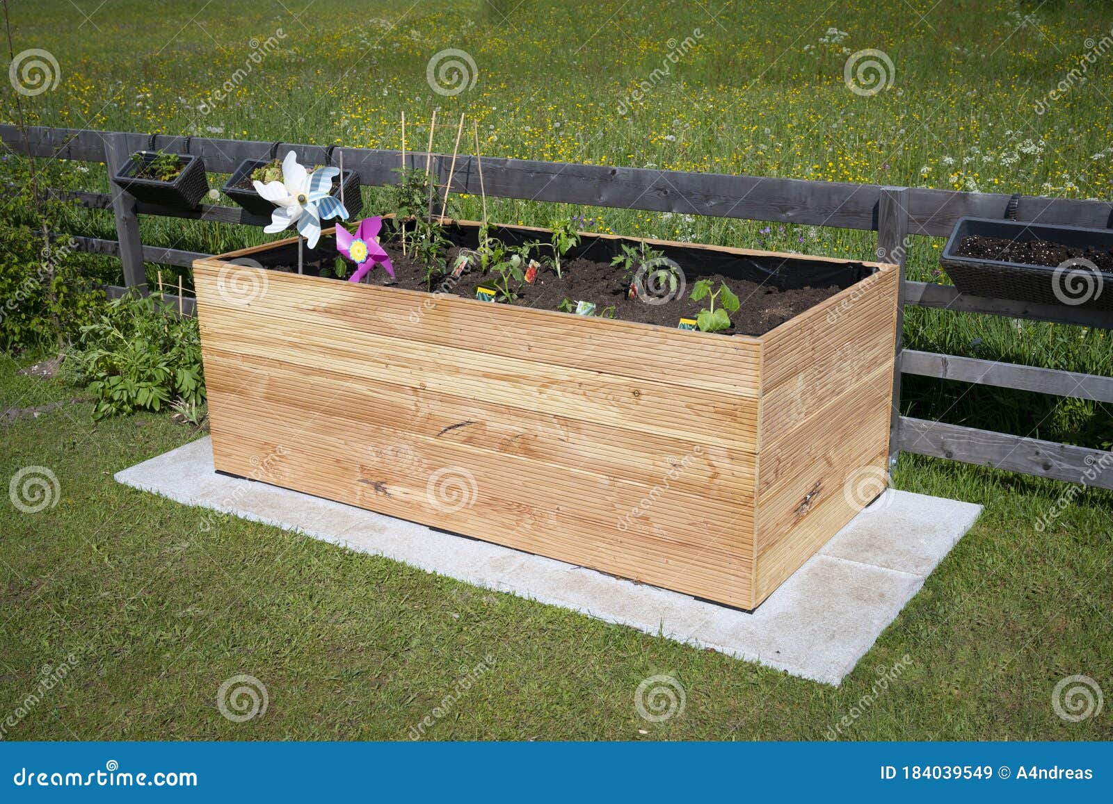 Rectangular Raised Bed Made of Wood on Granite Stones with Small Plants ...