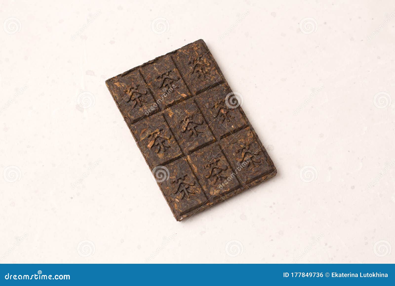 A Rectangular Tile Brick of Chinese Puer Tea with Hieroglyphs Lies on a ...