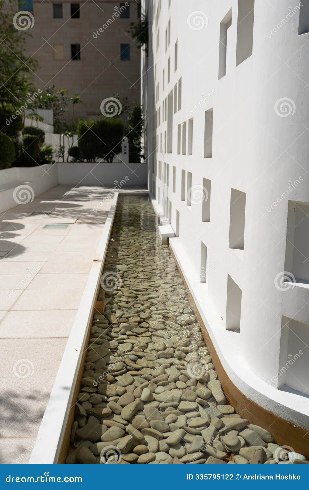 Rectangular Water Feature Filled with Smooth Stones, Reflecting a ...