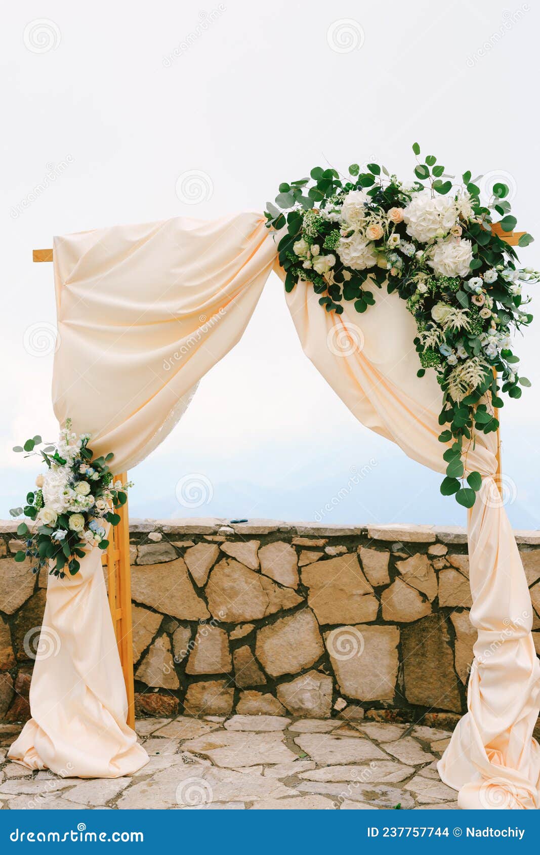 Rectangular Wedding Arch Decorated with Fabric and Flowers Stands on ...