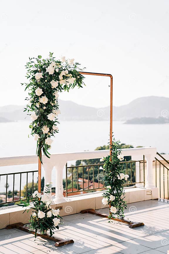 Rectangular Wedding Arch Stands on a Terrace Above the Sea Against the ...