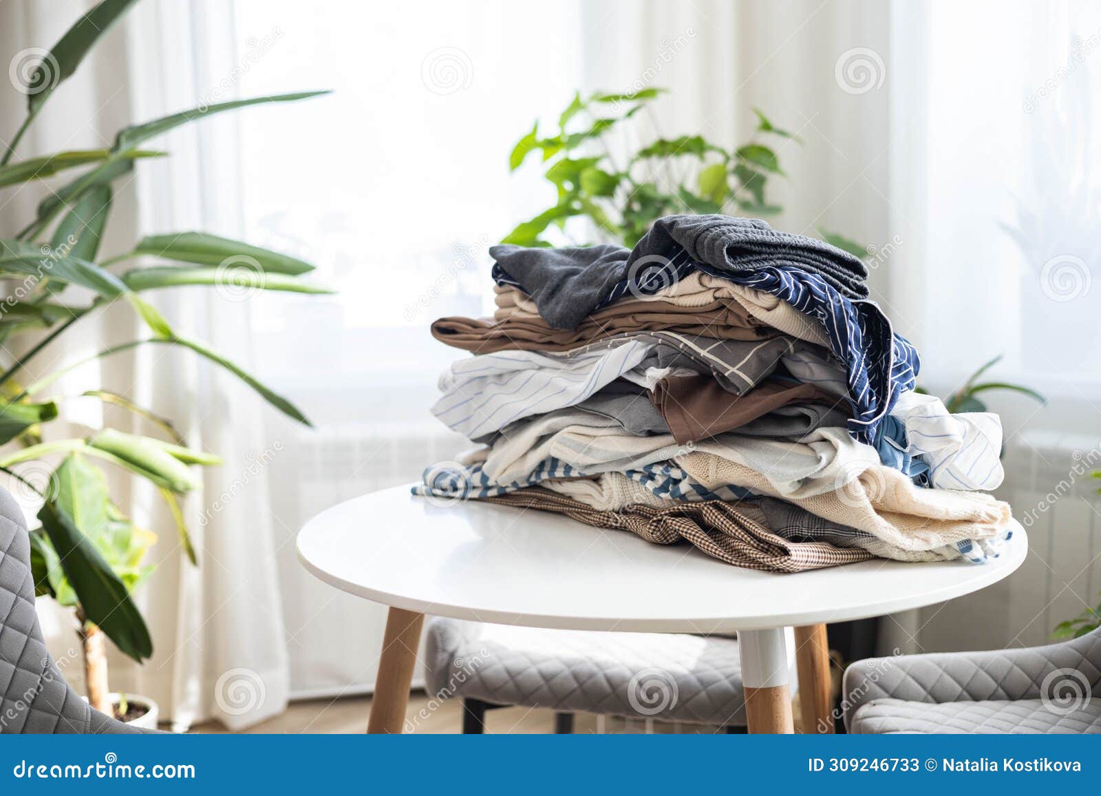 Recycling or Donation Concept. a Stack of Clothes Lies on the Table at ...