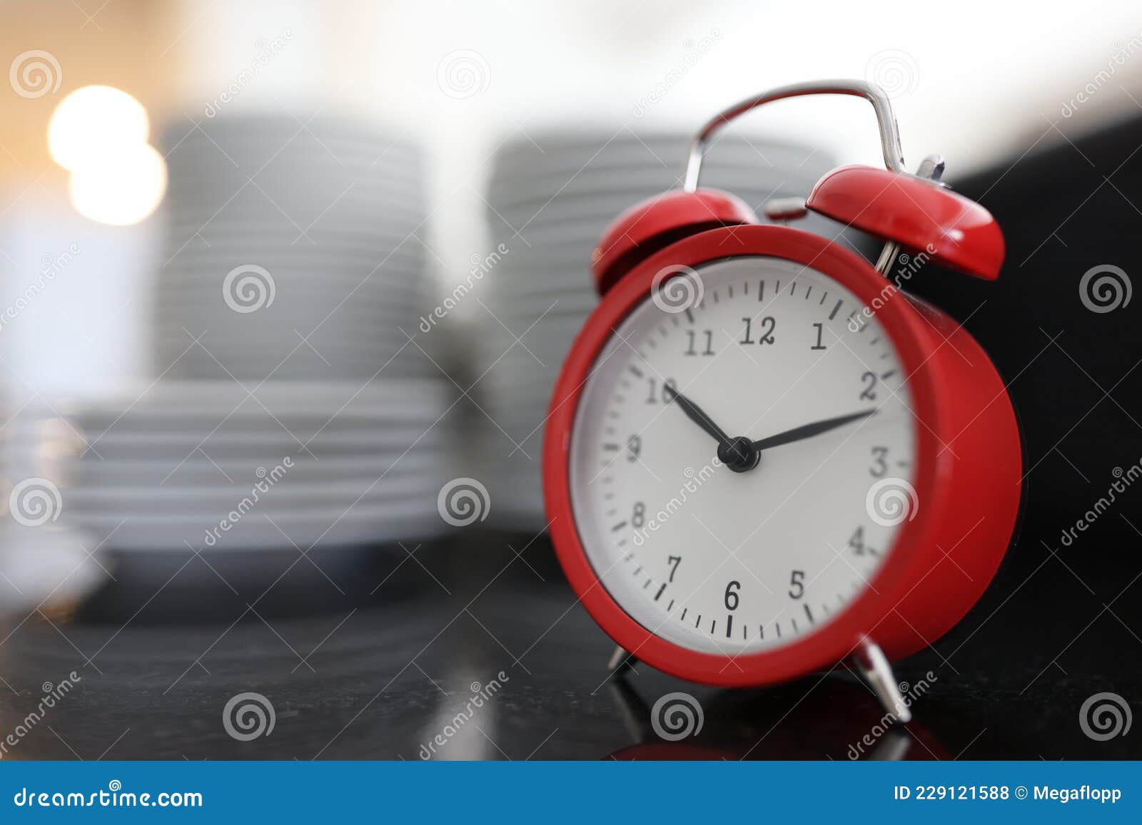 Red Alarm Clock on Background of Large Stack of Plates Stock Photo ...