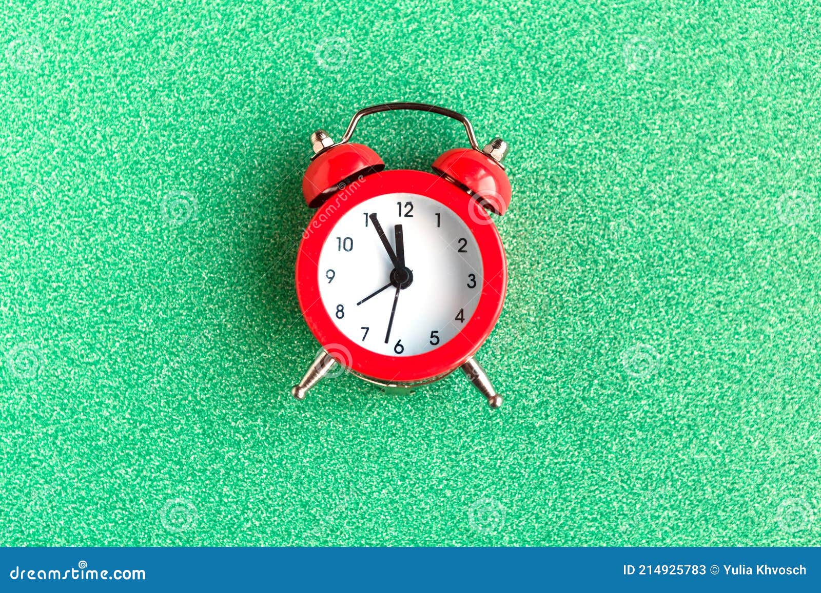 Red Alarm Clock on Green Glitter Background. Stock Image - Image of ...