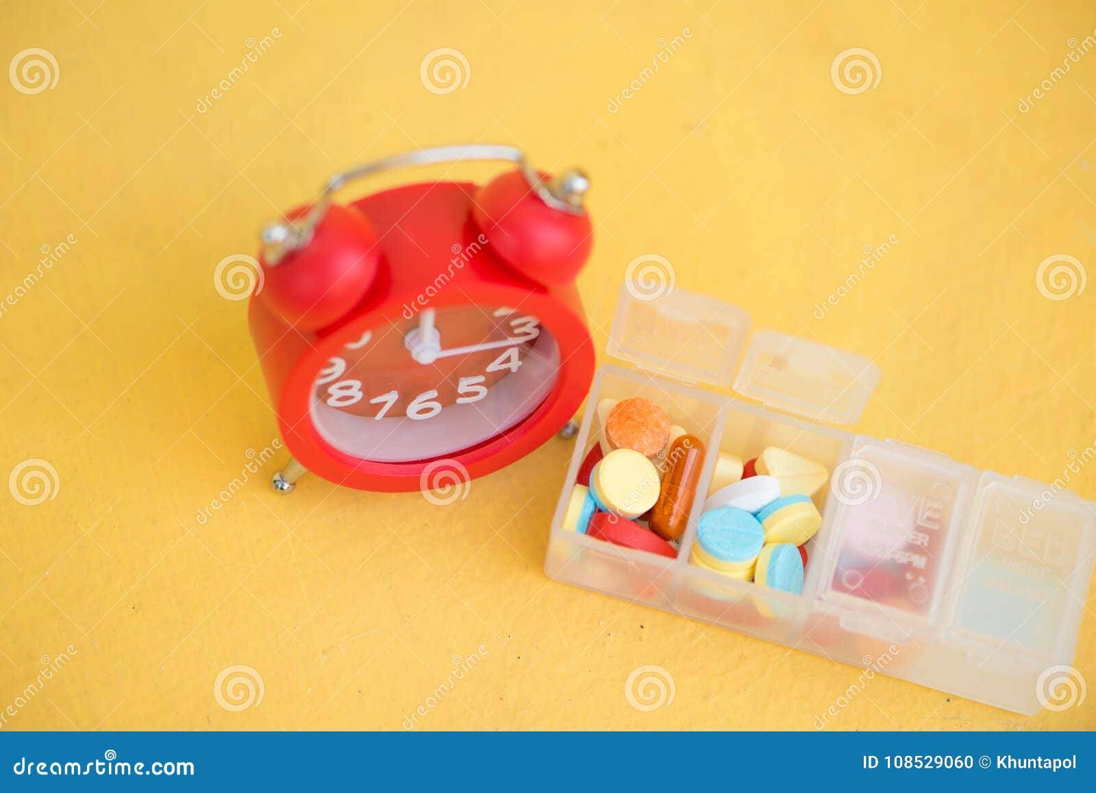 Red Alarm Clock and daily Pill Box Stock Photo - Image of drug, hand ...