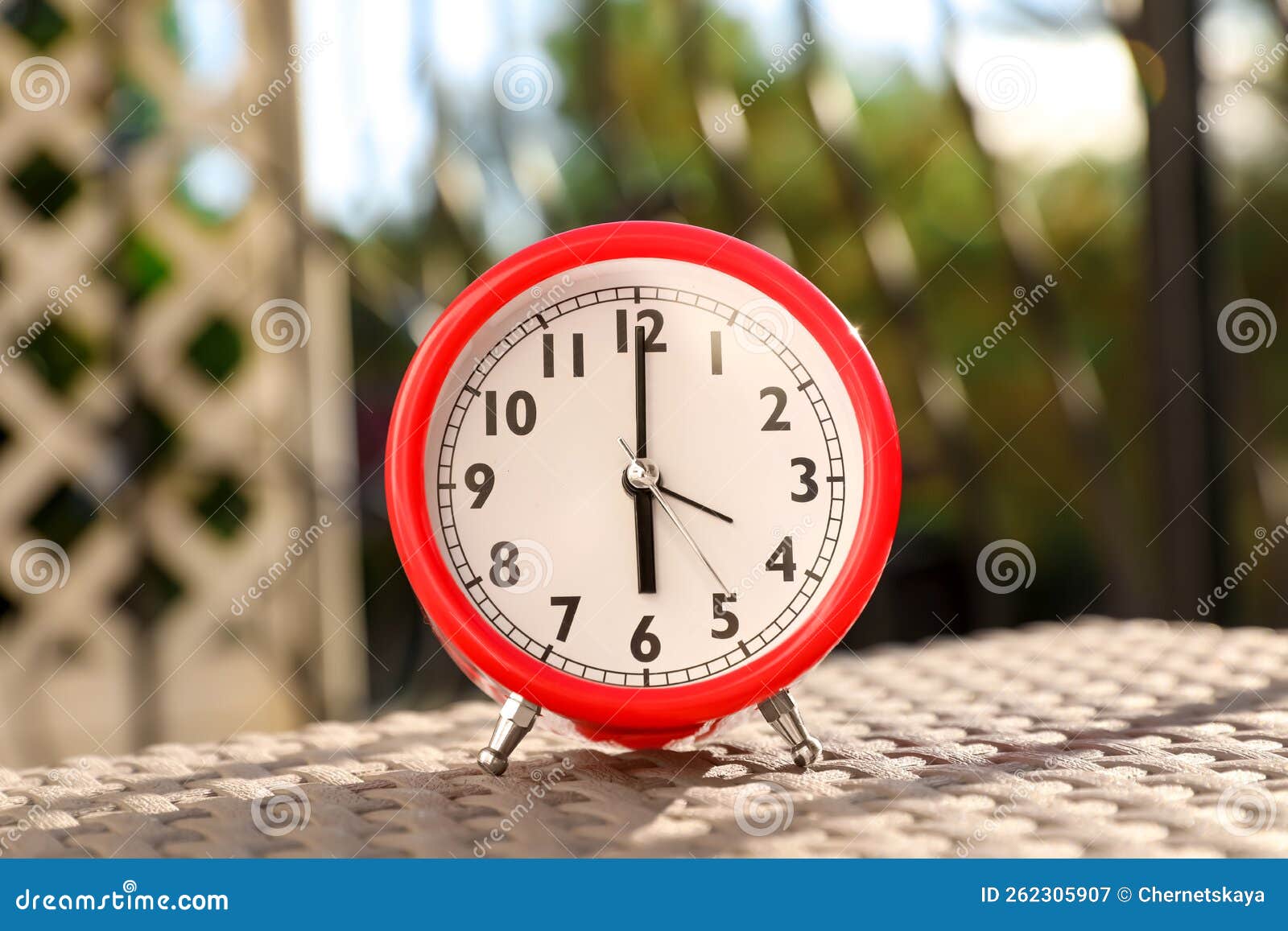 Red Alarm Clock on Table Outdoors at Sunny Morning Stock Image - Image ...