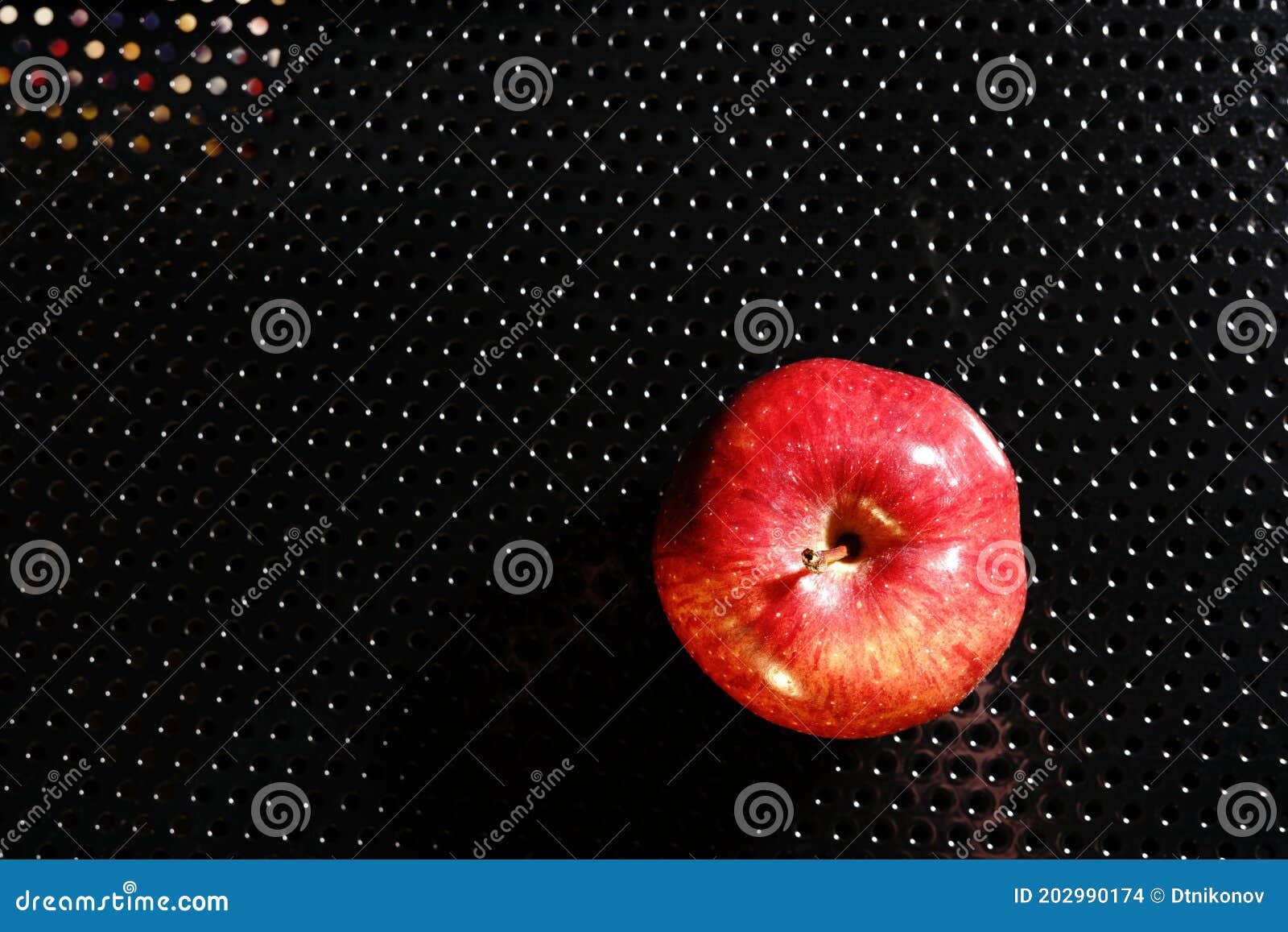 Red Apple on a Black Background. Half-light and a Brightly Lit Apple ...