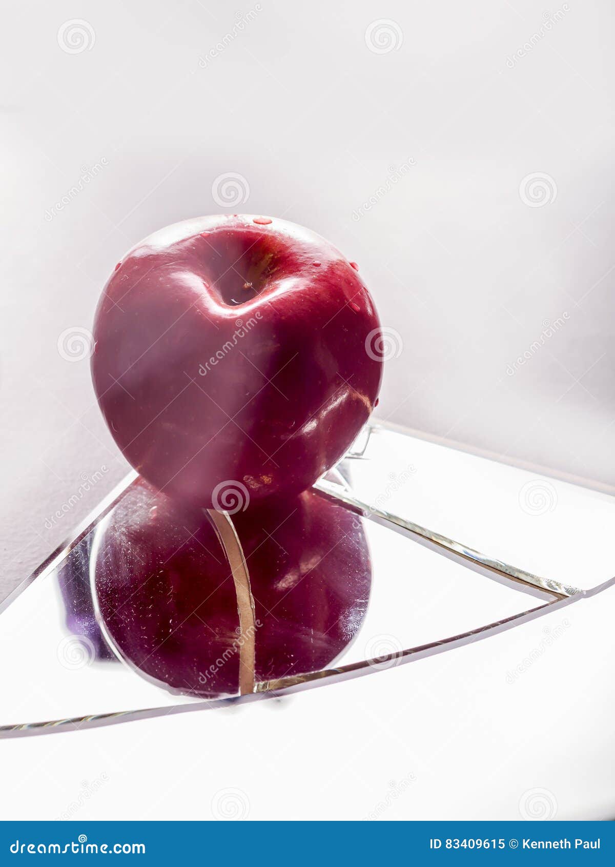 Red apple on broken mirror stock image. Image of fruit - 83409615