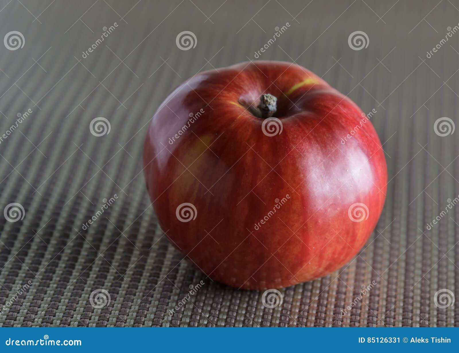 Red Apple on grey material stock image. Image of closeup - 85126331