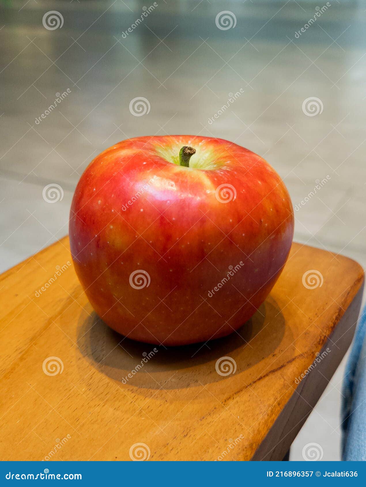 A Red Apple Sitting on a Wooden Bench Top Stock Image - Image of flower ...