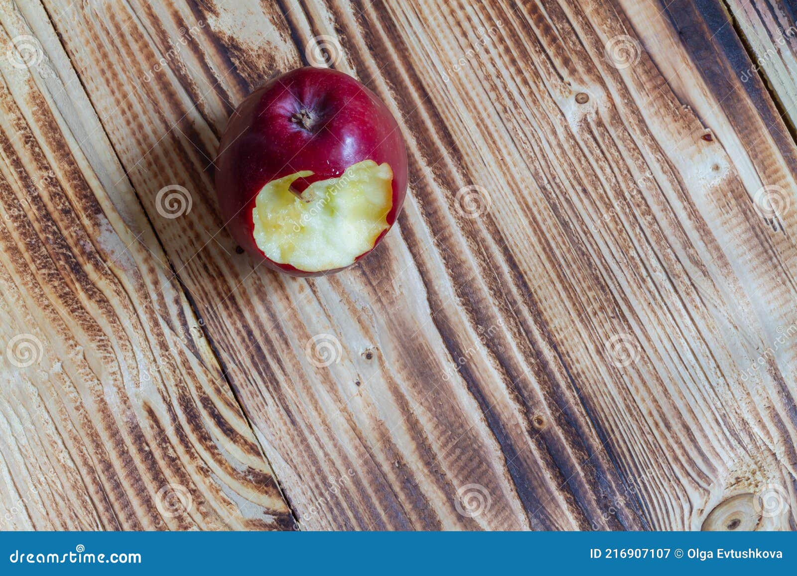 A Red Apple with a Tooth Mark on a Wooden Background Stock Image ...