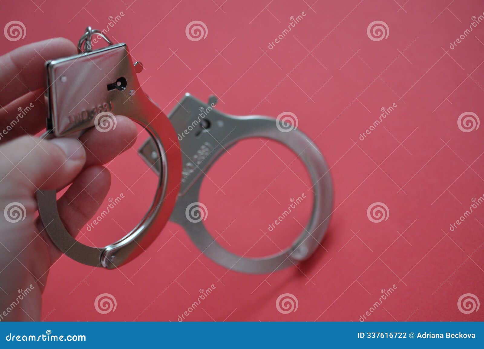 Handcuffs in hand stock photo. Image of handcuffs, glasses - 337616722