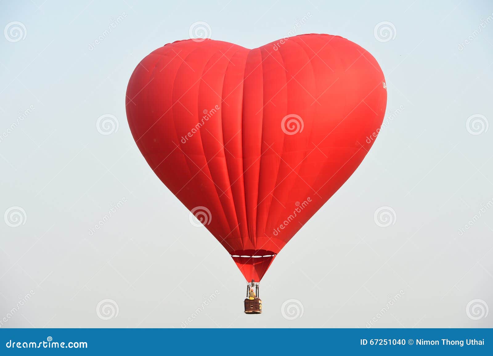 Red Balloon in the Shape of a Heart Against the Blue Sky Stock Photo ...