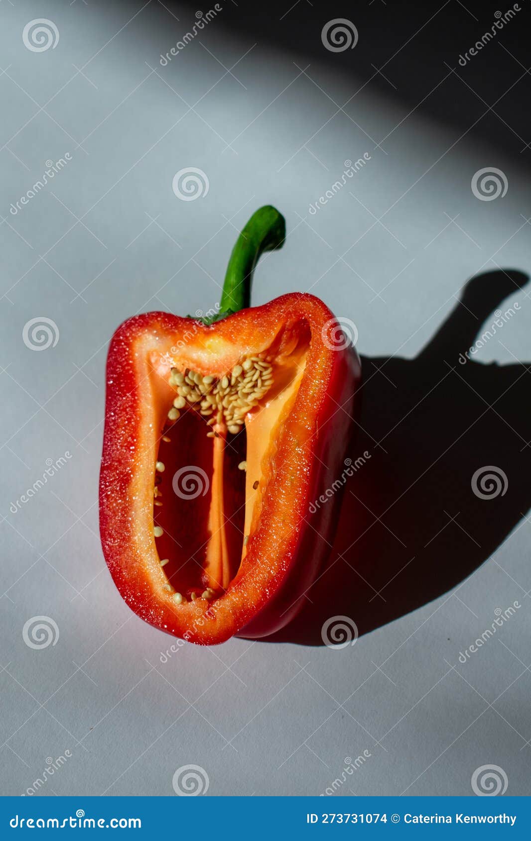 Red Bell Pepper Cut in Half, Cross Section Against Dark Background with ...