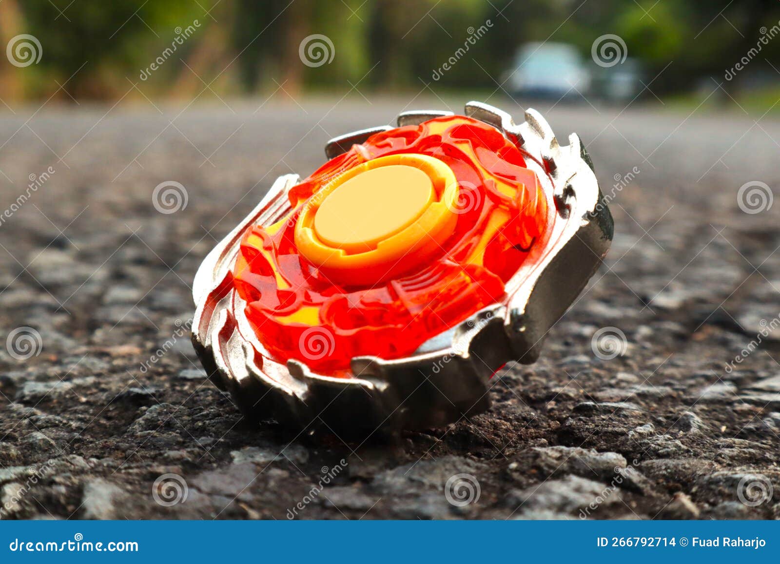 Red Beyblade is on the Asphalt Stock Photo - Image of ashphalt, light ...