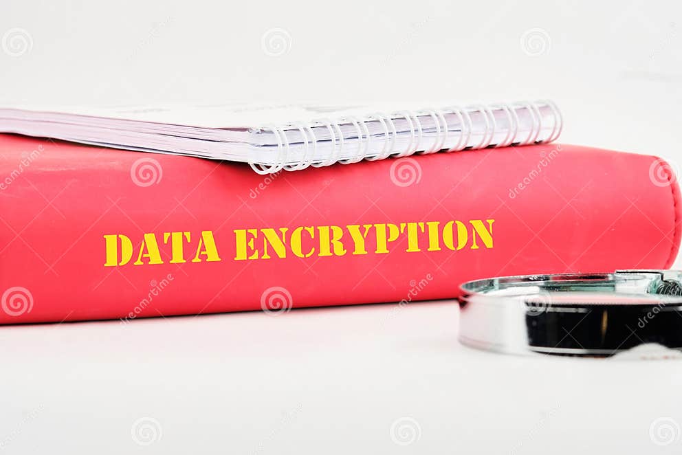 A Red Binder Labeled Data Encryption Rests on a Surface Alongside a ...