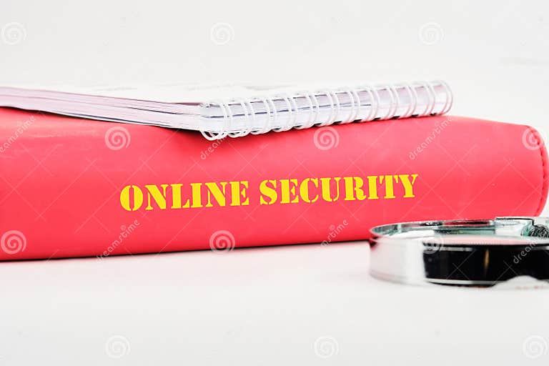 A Red Binder Labeled Online Security Rests on a Clean Surface Next To a ...