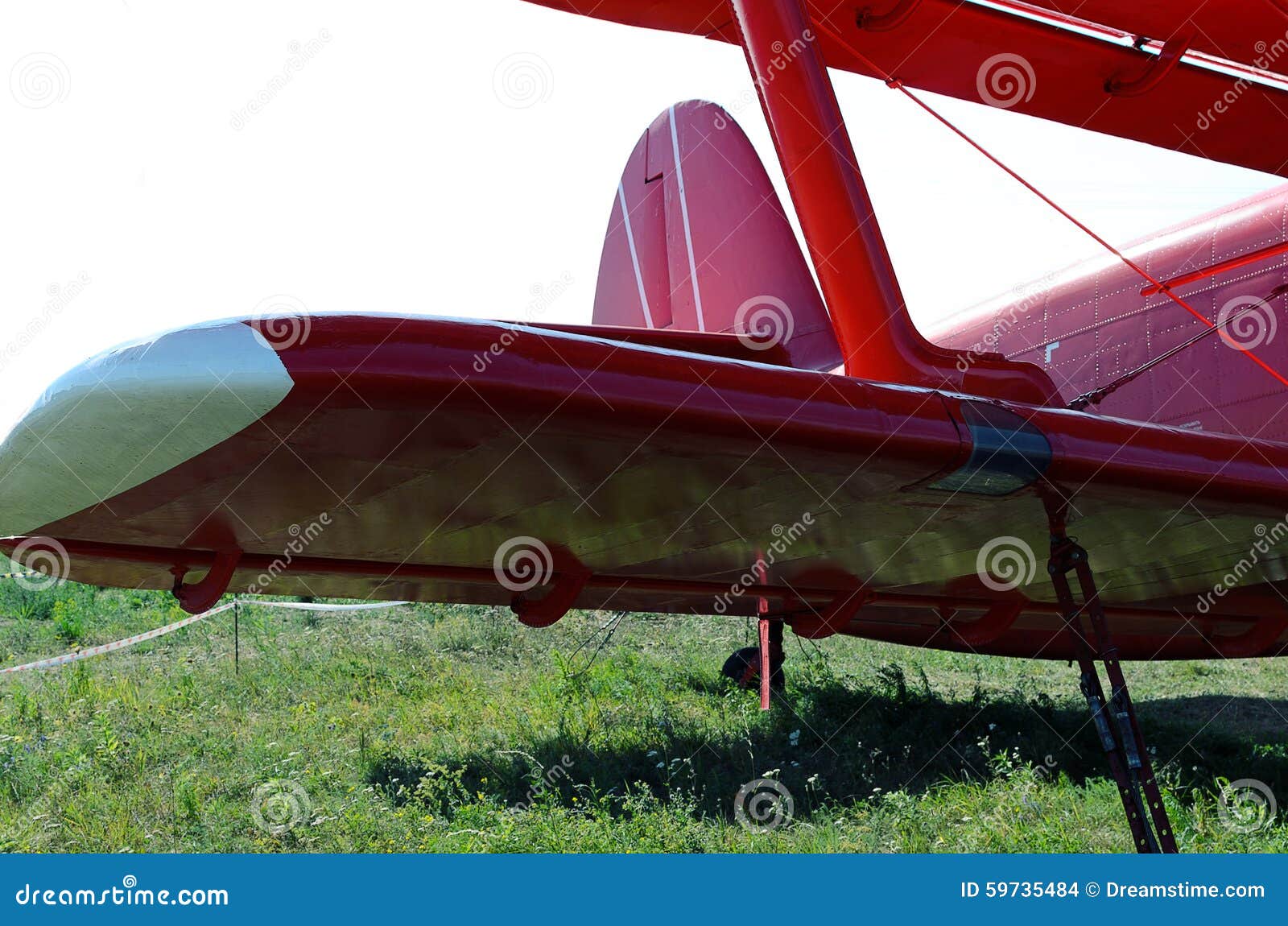 Red Biplane Wing on the Ground Stock Photo - Image of vehicle, aircraft ...