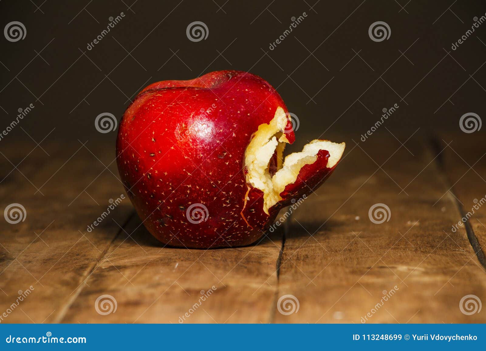 Red Bitten Apple on an Oak Table. Apple Red Bitten on the Table Close ...