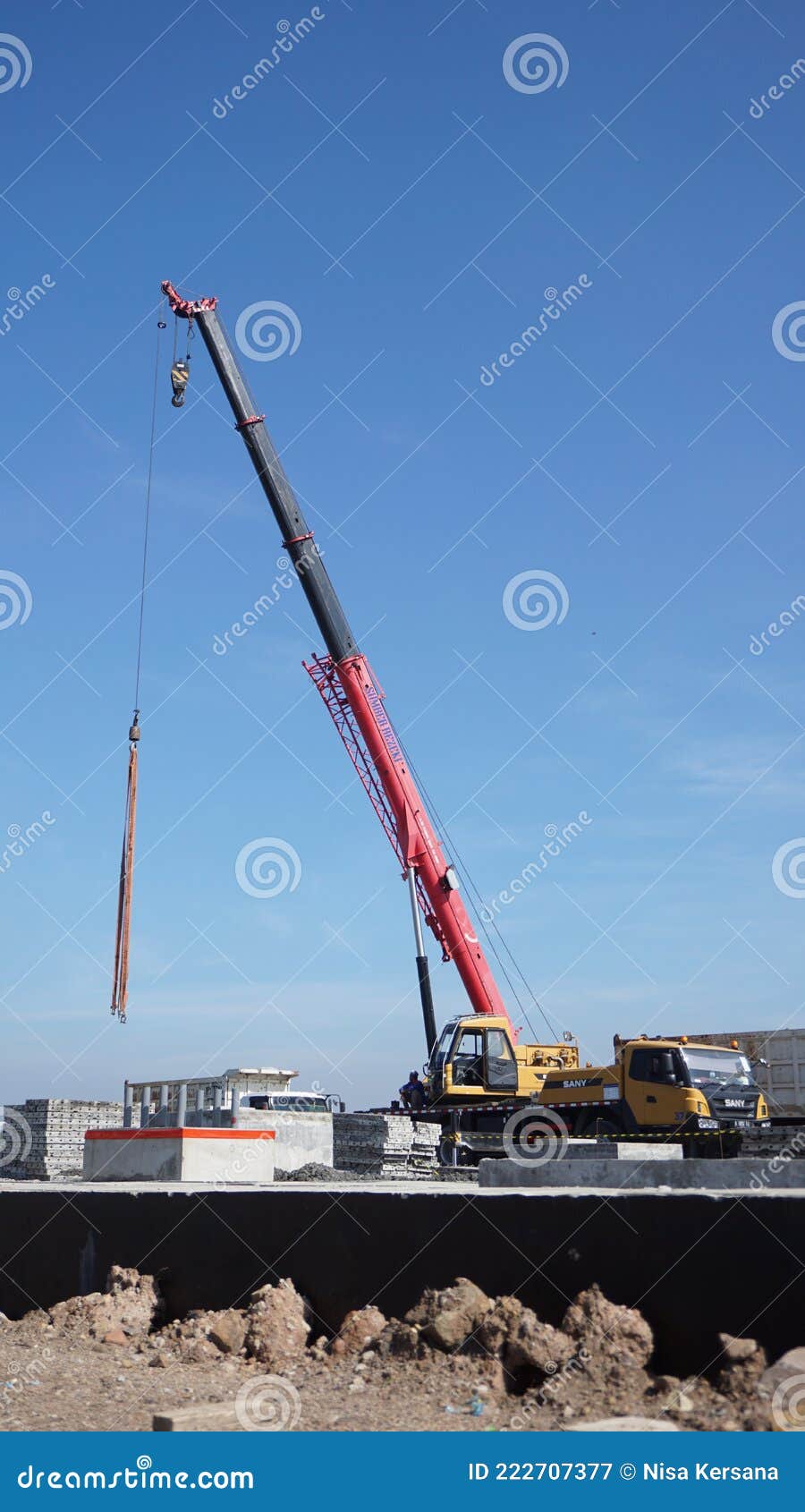 Red Black Crane and Yellow Truck on a Construction Site Editorial ...