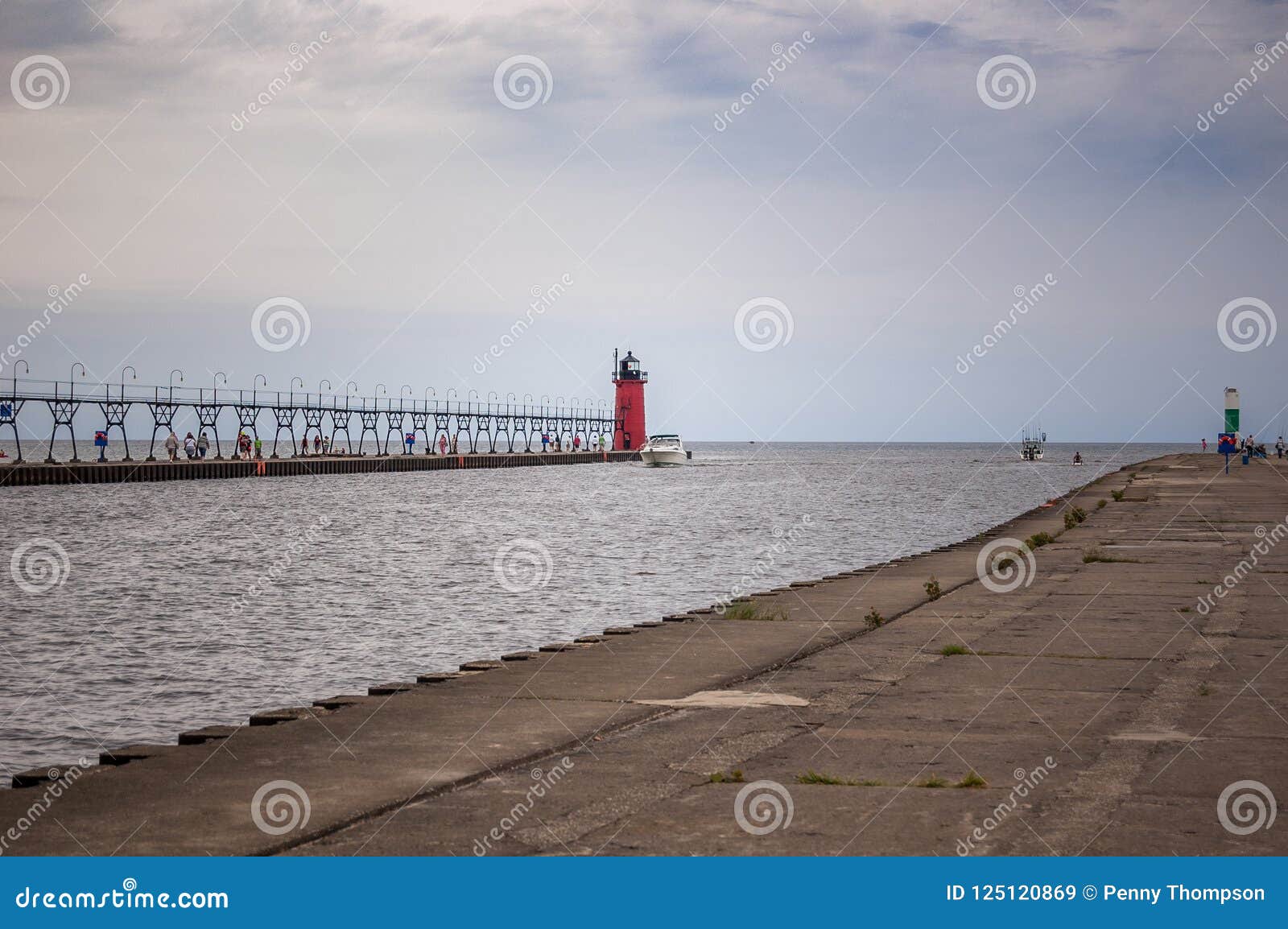 Lighthouse at end of pier stock image. Image of black - 125120869