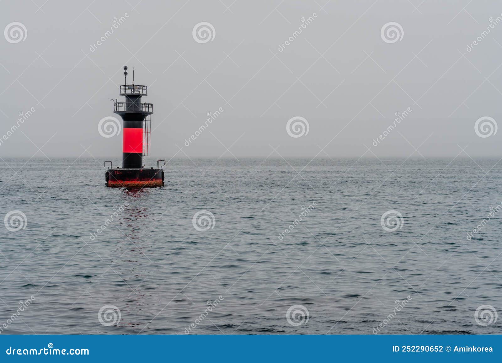 Red and Black Lighthouse Offshore Stock Photo - Image of hazy, port ...