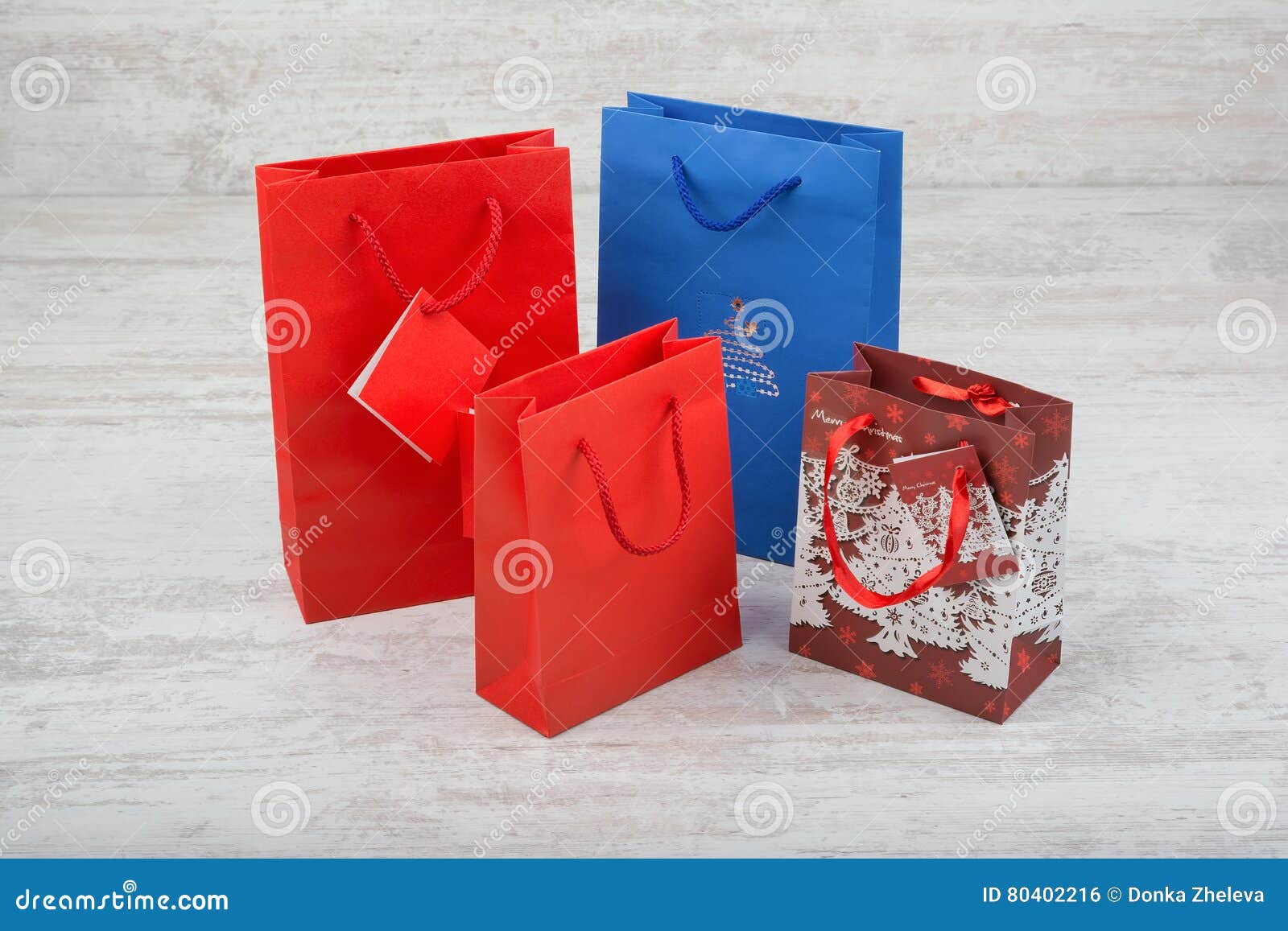 Red and Blue Gift Bags on a White Wooden Background Stock Photo - Image ...