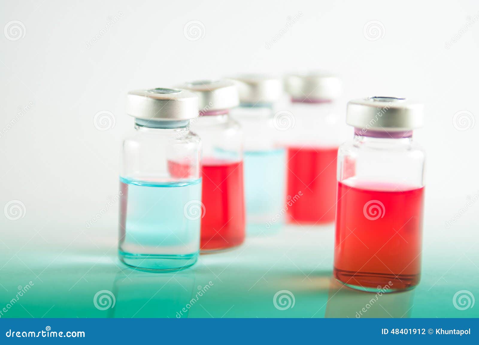 Red and Blue Liquid in Injection Vials on Red Floor Effect Stock Photo ...