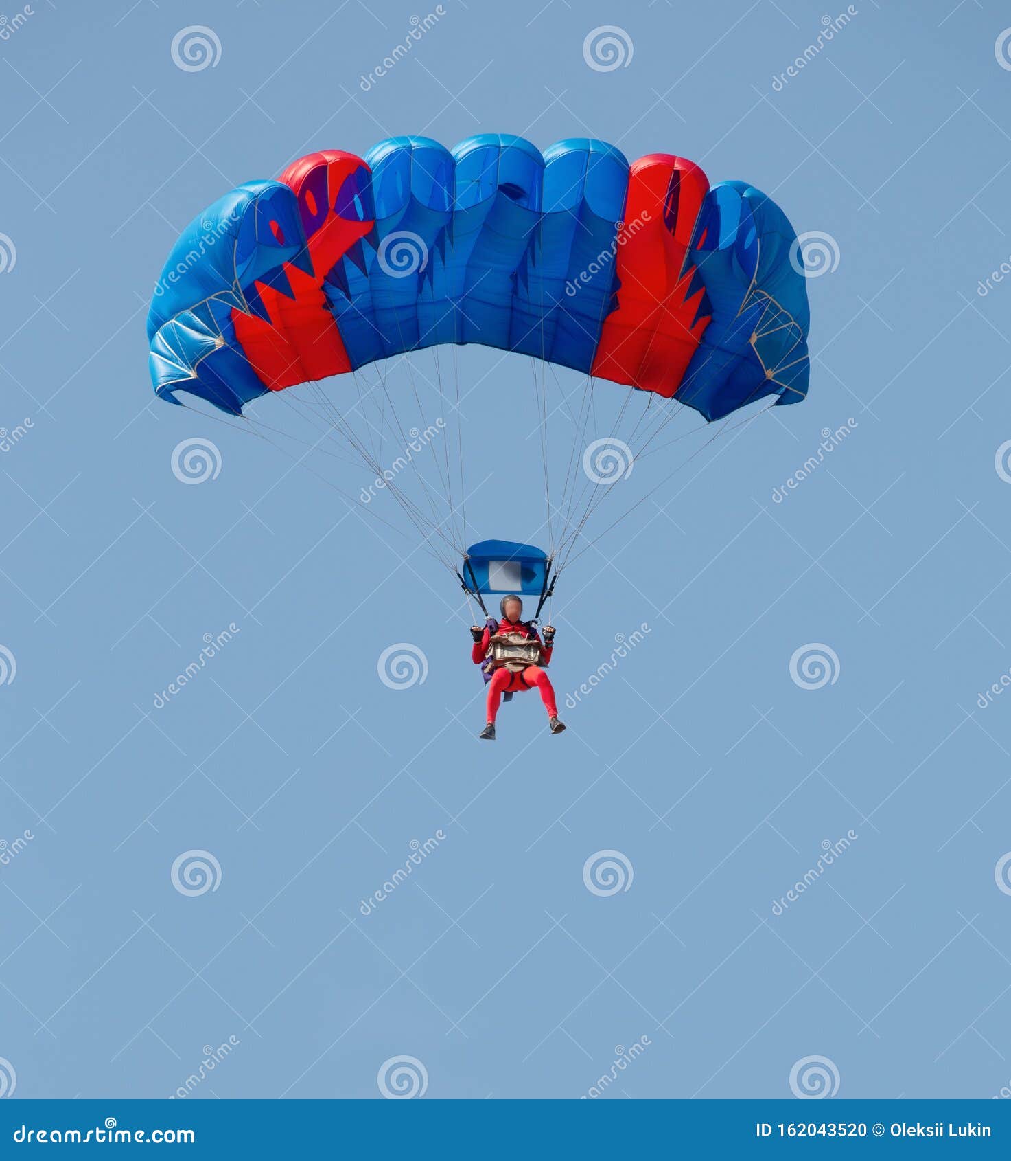 Red and Blue Parachute with Paratrooper in Sky Stock Photo - Image of ...