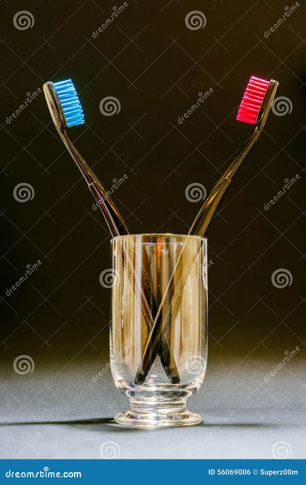 Red and Blue Teeth Brushes in a Glass on Black Background. Stock Photo ...
