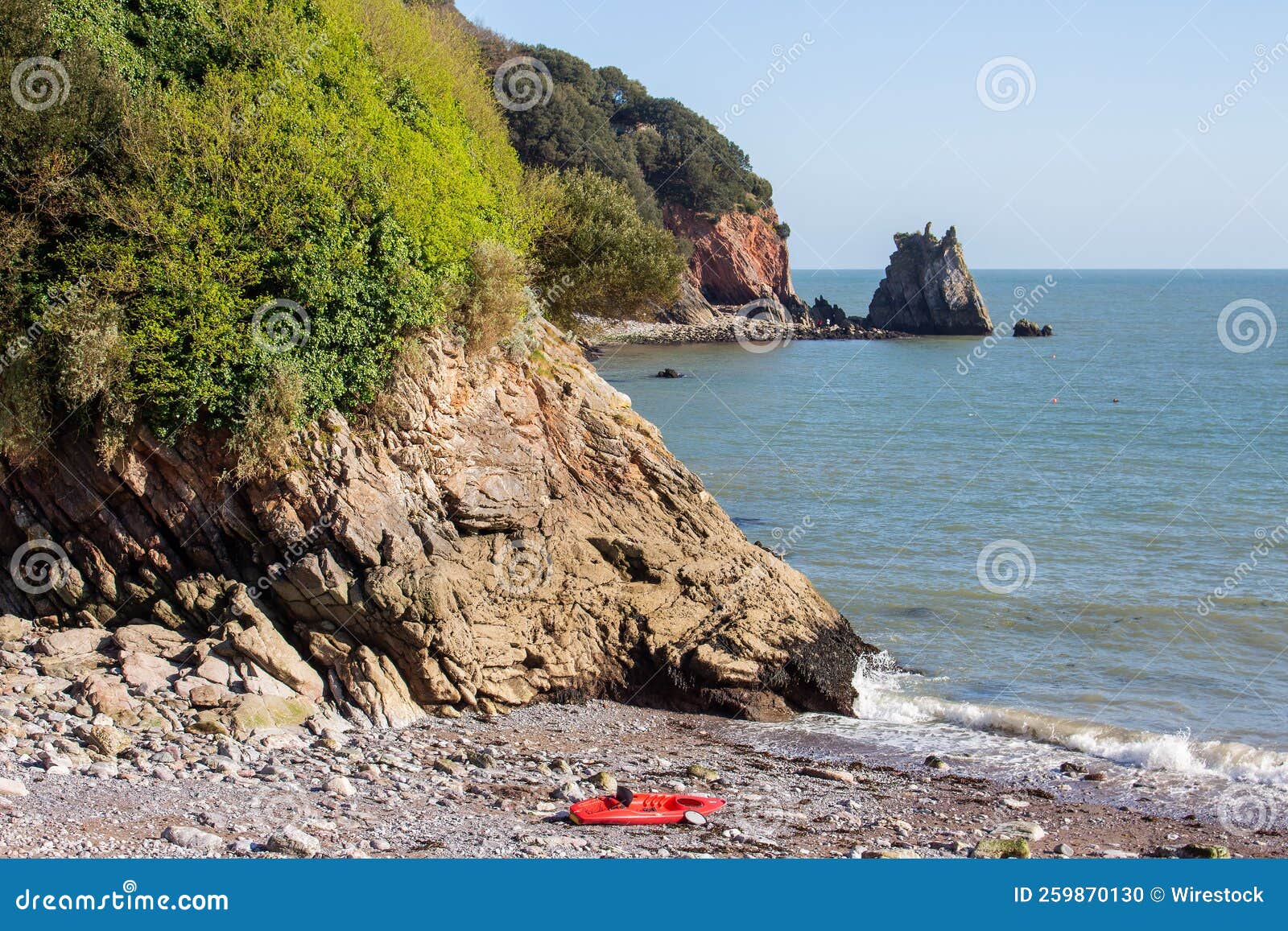 Red Boat on a Coast Surrounded by Forested Cliffs Stock Photo - Image ...