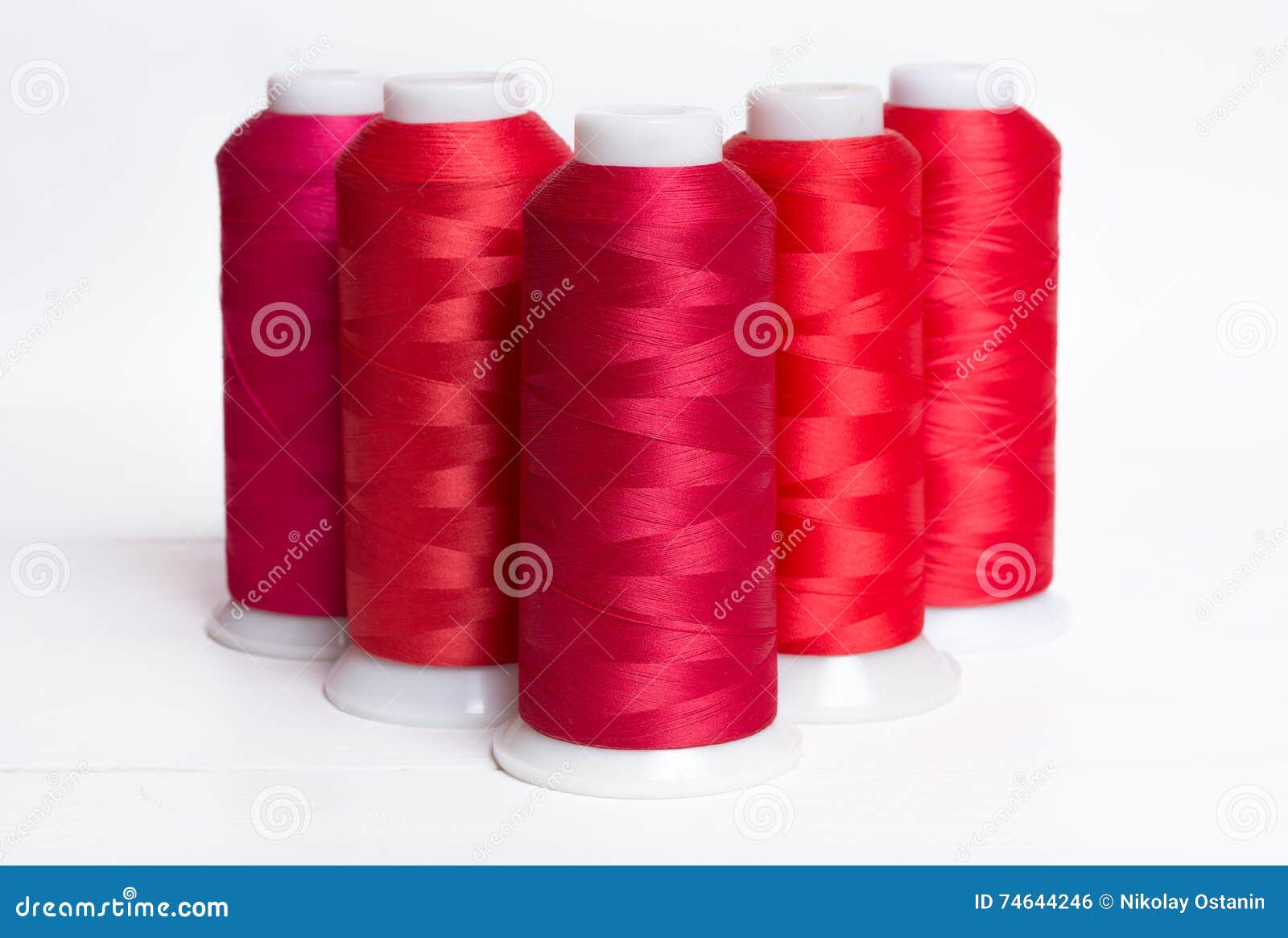 Red Bobbin Thread on White Wooden Table Stock Photo - Image of reel ...