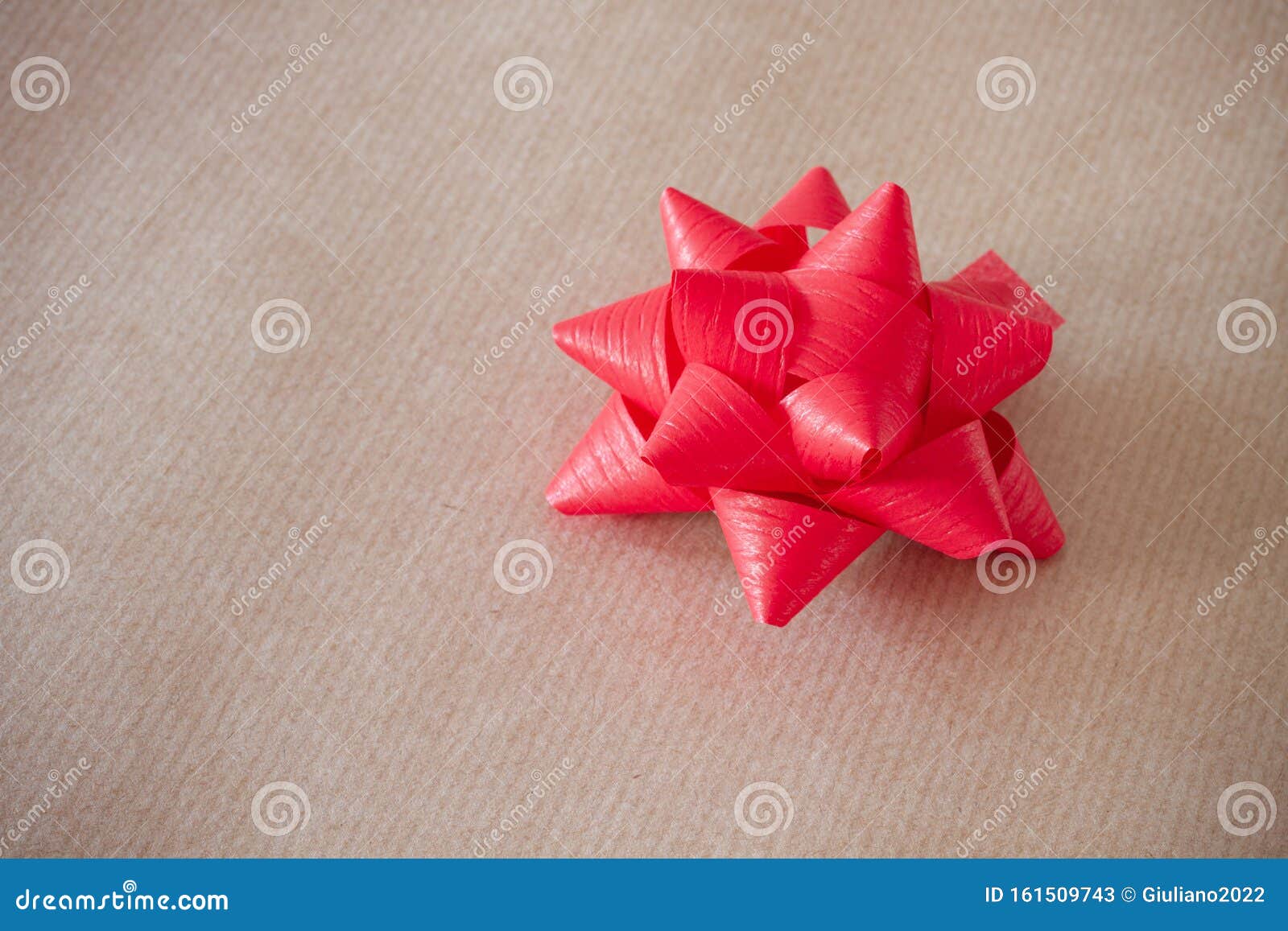 Red bow on brownish paper stock image. Image of cardboard - 161509743