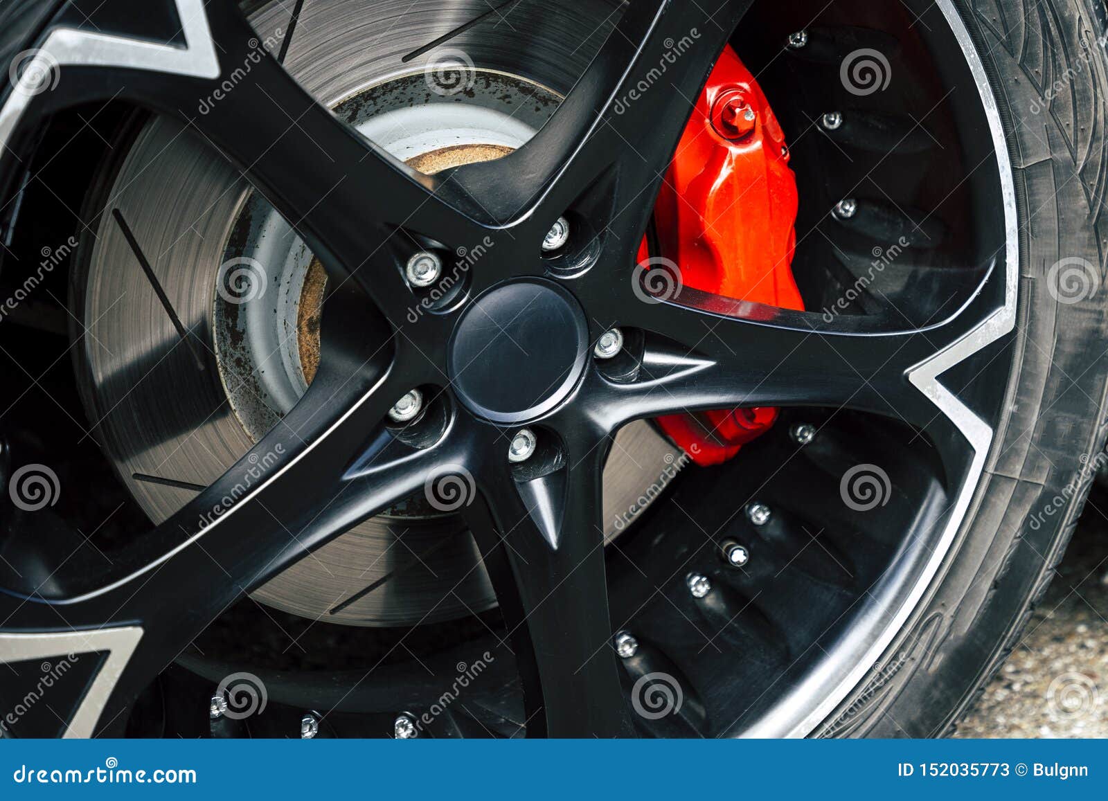 Red Brake Pads and Discs of Modern Car with Black Alloy Discs. Stock ...