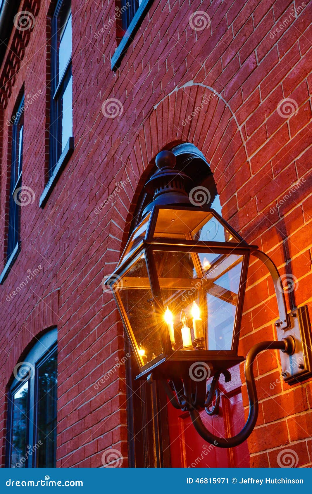 Red Brick Building Facade with Light in Forground Stock Image - Image ...